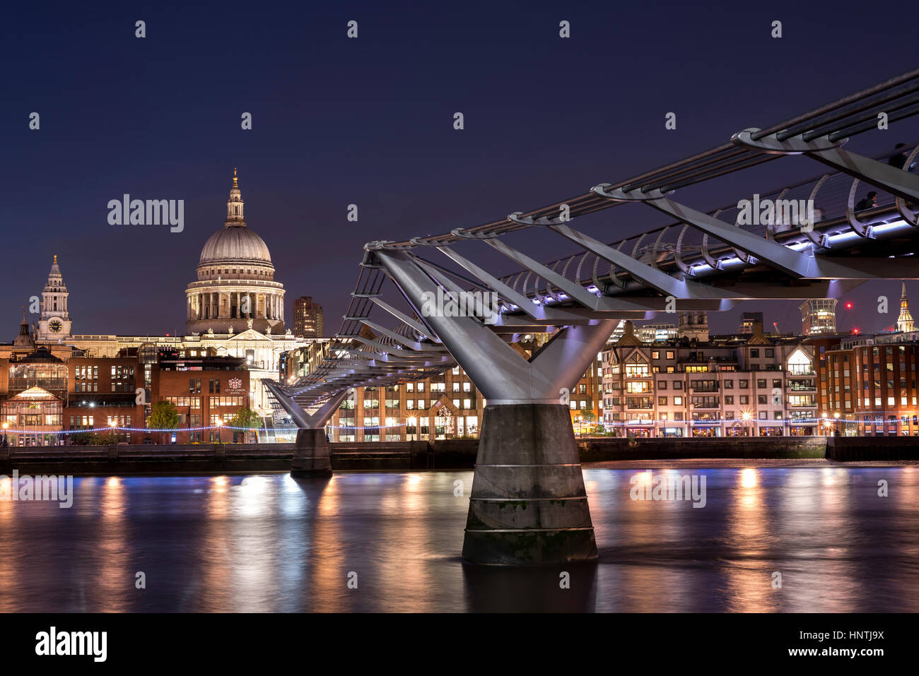 Night time view of the Millennium Bridge and River Thames, London, UK ...