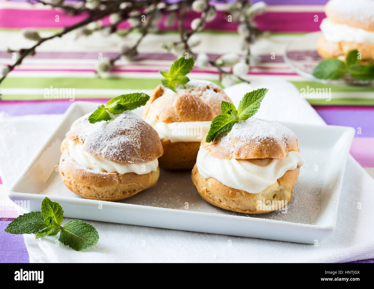Profiteroles, cream puff, traditional French dessert on white plate ...