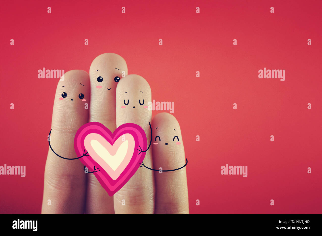 Four fingers decorated as four person hugging together Stock Photo - Alamy