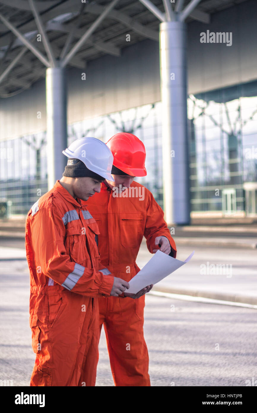 team of young engineers discussing construction project. The wear ...