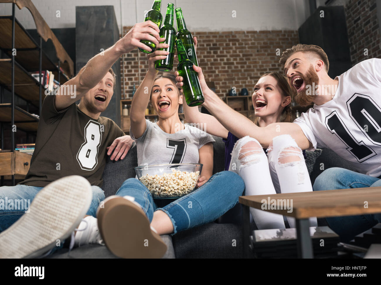 friends clinking beer bottles Stock Photo - Alamy