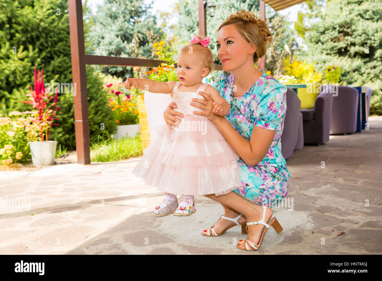 Happy mom and child girl hugging in outdoor. The concept of childhood and family. Portrait ...