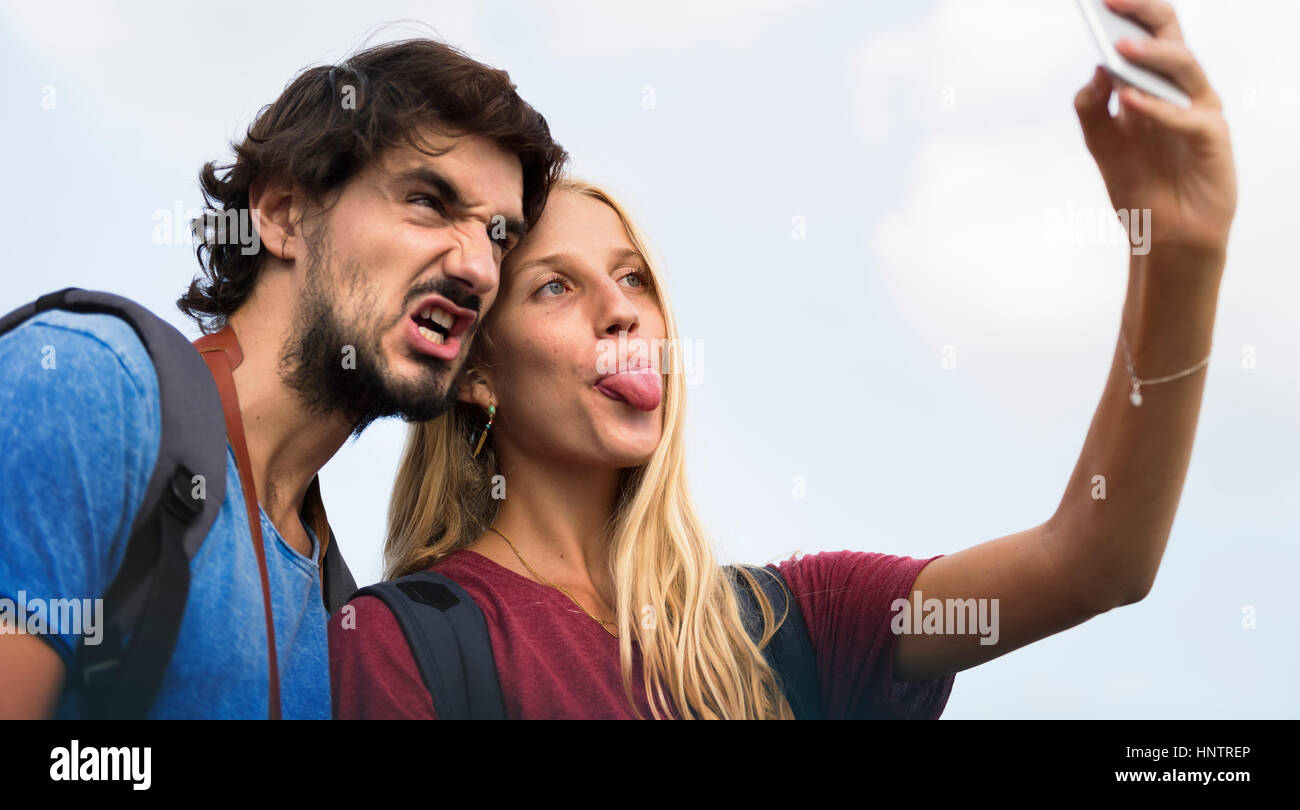 Couple taking a wacky selfie tongue out Stock Photo - Alamy