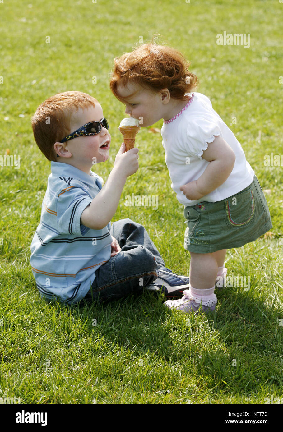 Two children sharing ice cream hi-res stock photography and images - Alamy