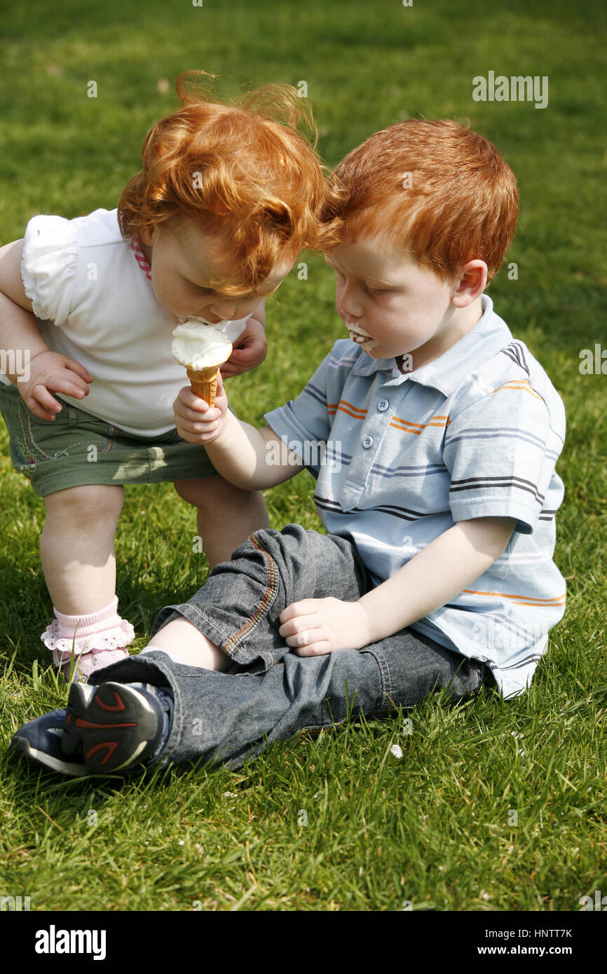 Two children sharing ice cream hi-res stock photography and images - Alamy