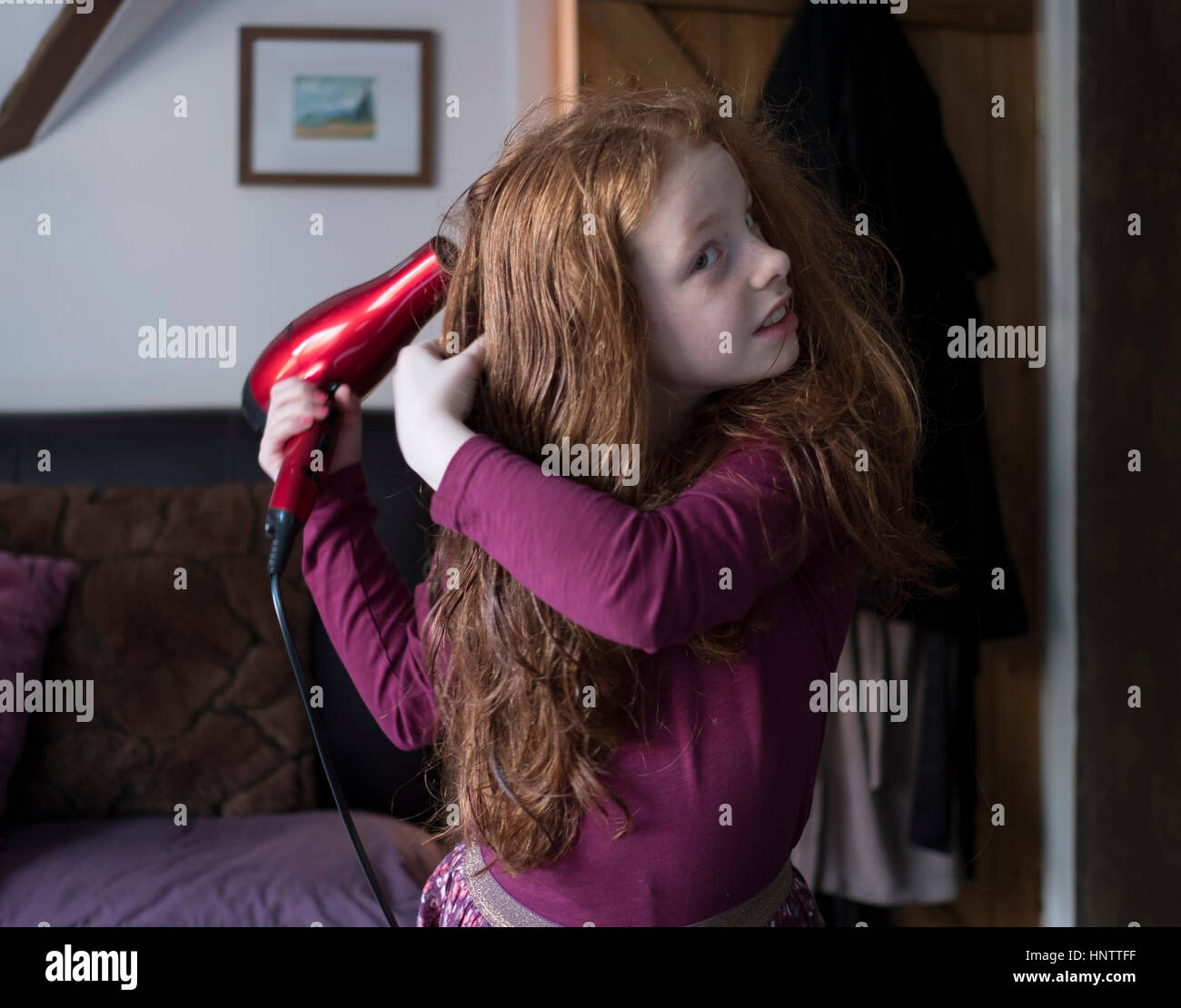 A little girl drying her hair with a hair dryer Stock Photo - Alamy