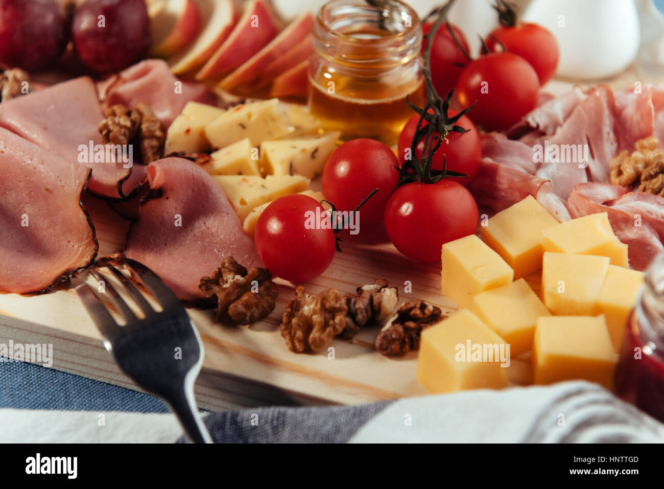 large wooden table meat, bread and vegetables Stock Photo - Alamy