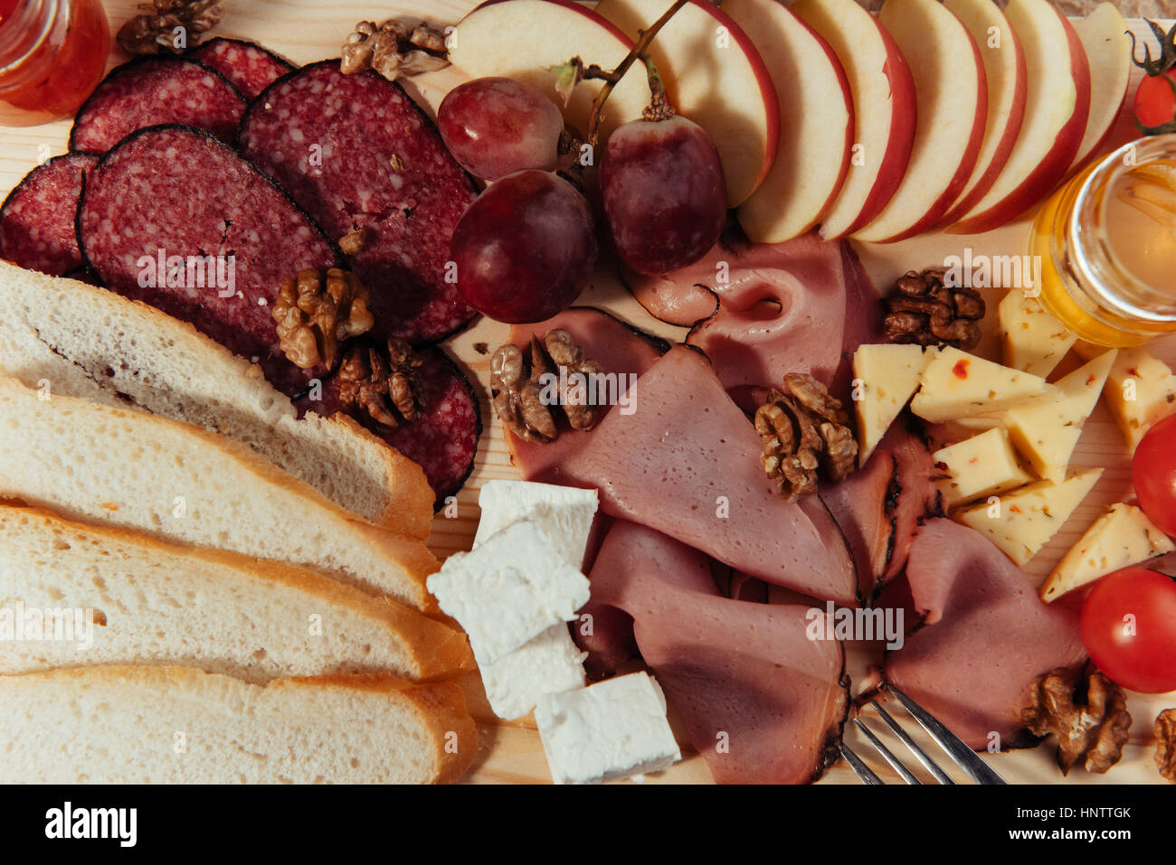 large wooden table meat, bread and vegetables Stock Photo - Alamy