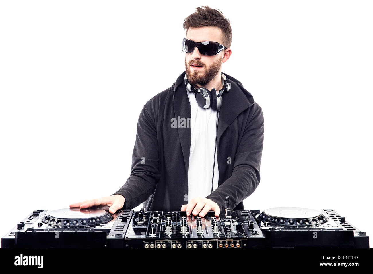Trendy male dj posing against mixing console Stock Photo - Alamy