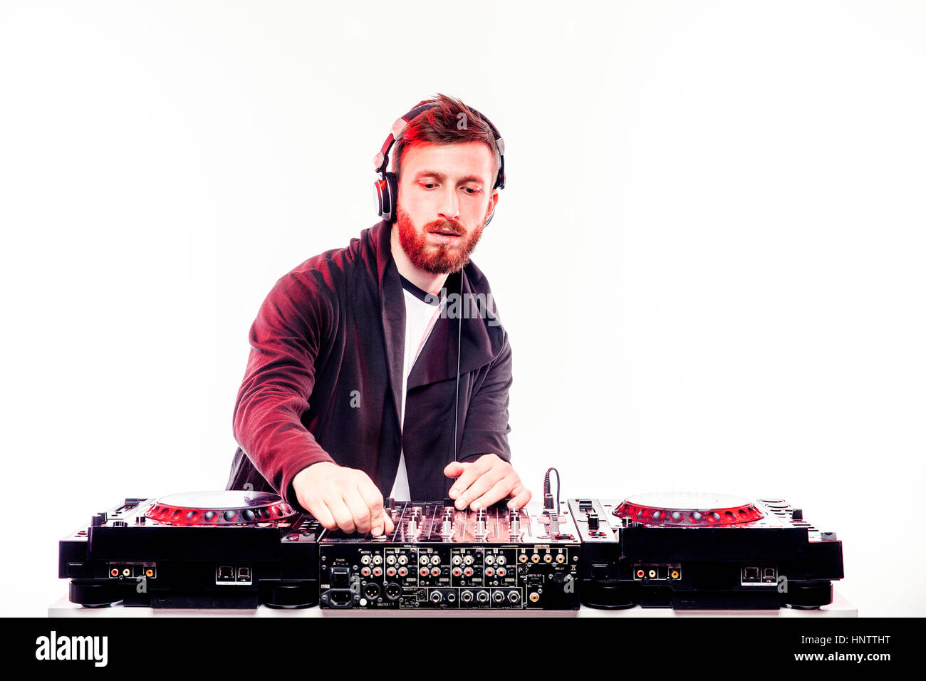 Trendy male dj posing against mixing console Stock Photo - Alamy