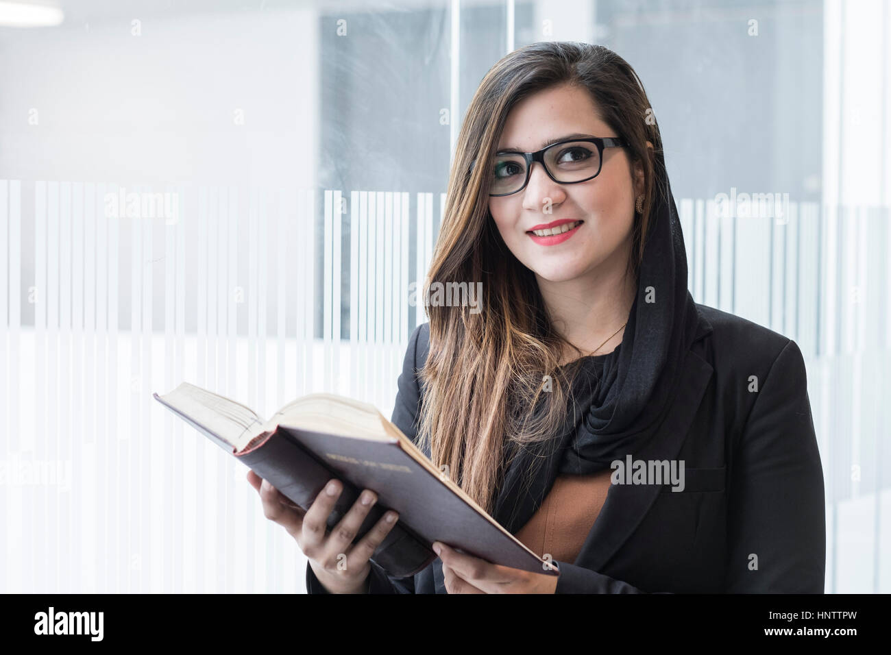 Female student with text books in a university setting Stock Photo - Alamy
