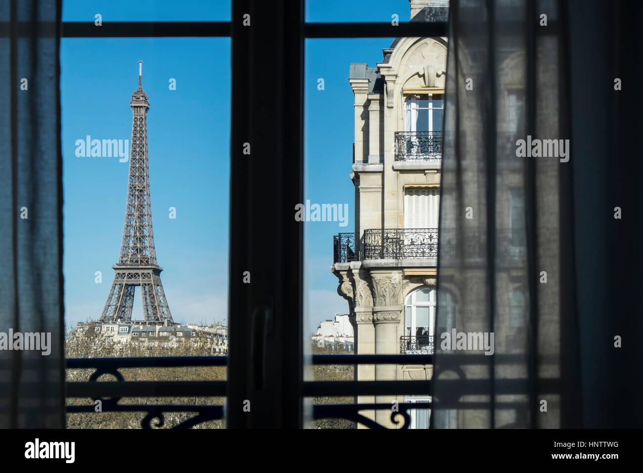 The Eiffel Tower, Paris, France, viewed through a window Stock Photo ...