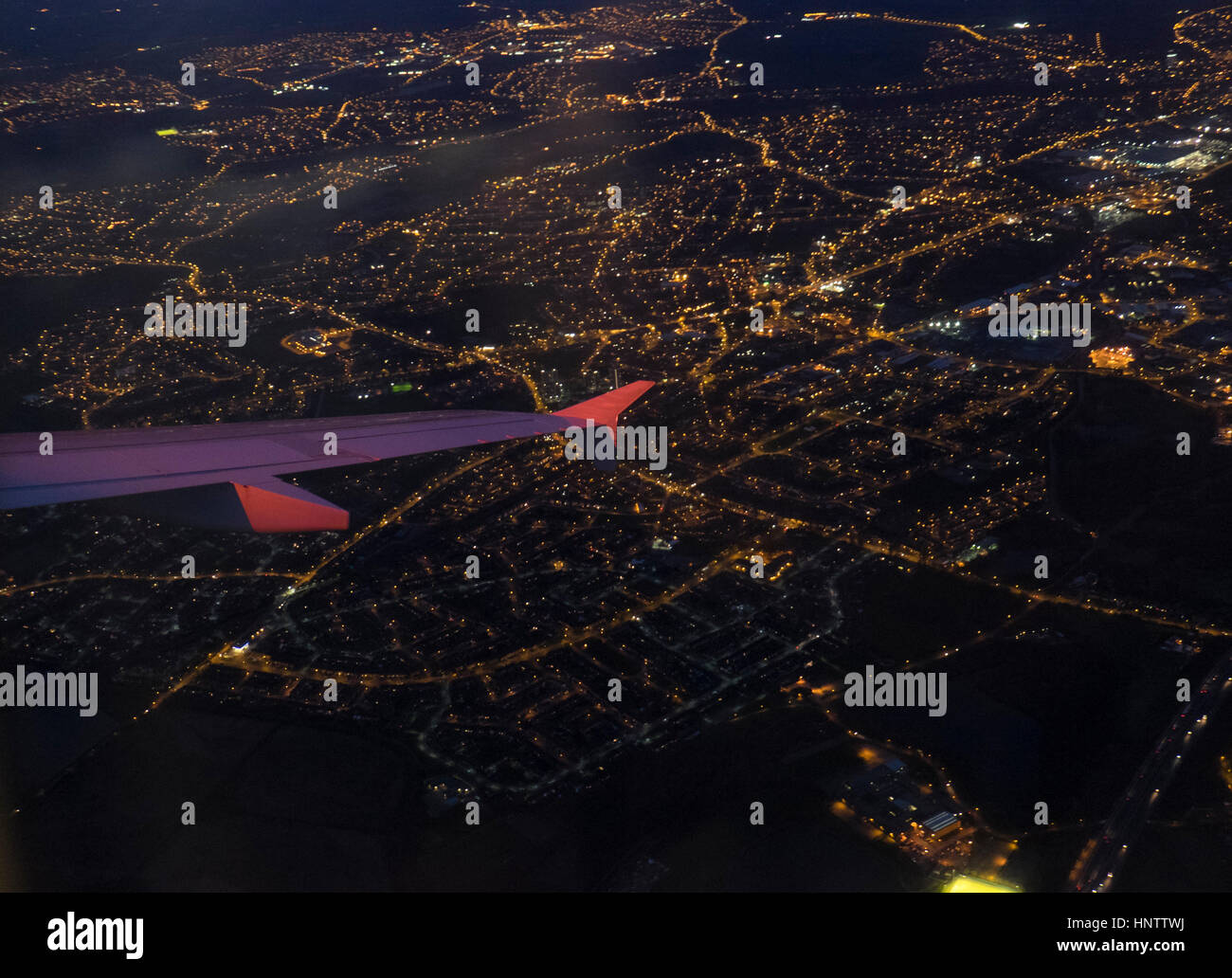 A city at night as seen from an aeroplane window Stock Photo - Alamy
