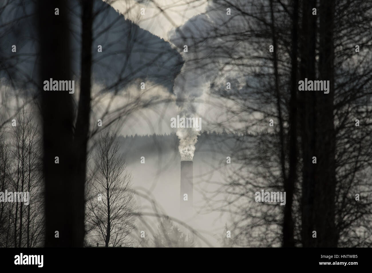 smokestack with heavy smoke seen from forest Stock Photo - Alamy