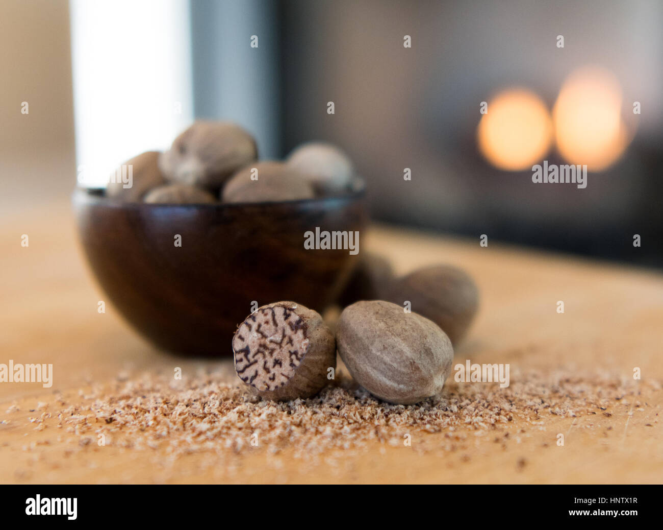Ground Nutmeg Rests in Front of a Bowl of Nutmeg on butcher block Stock ...
