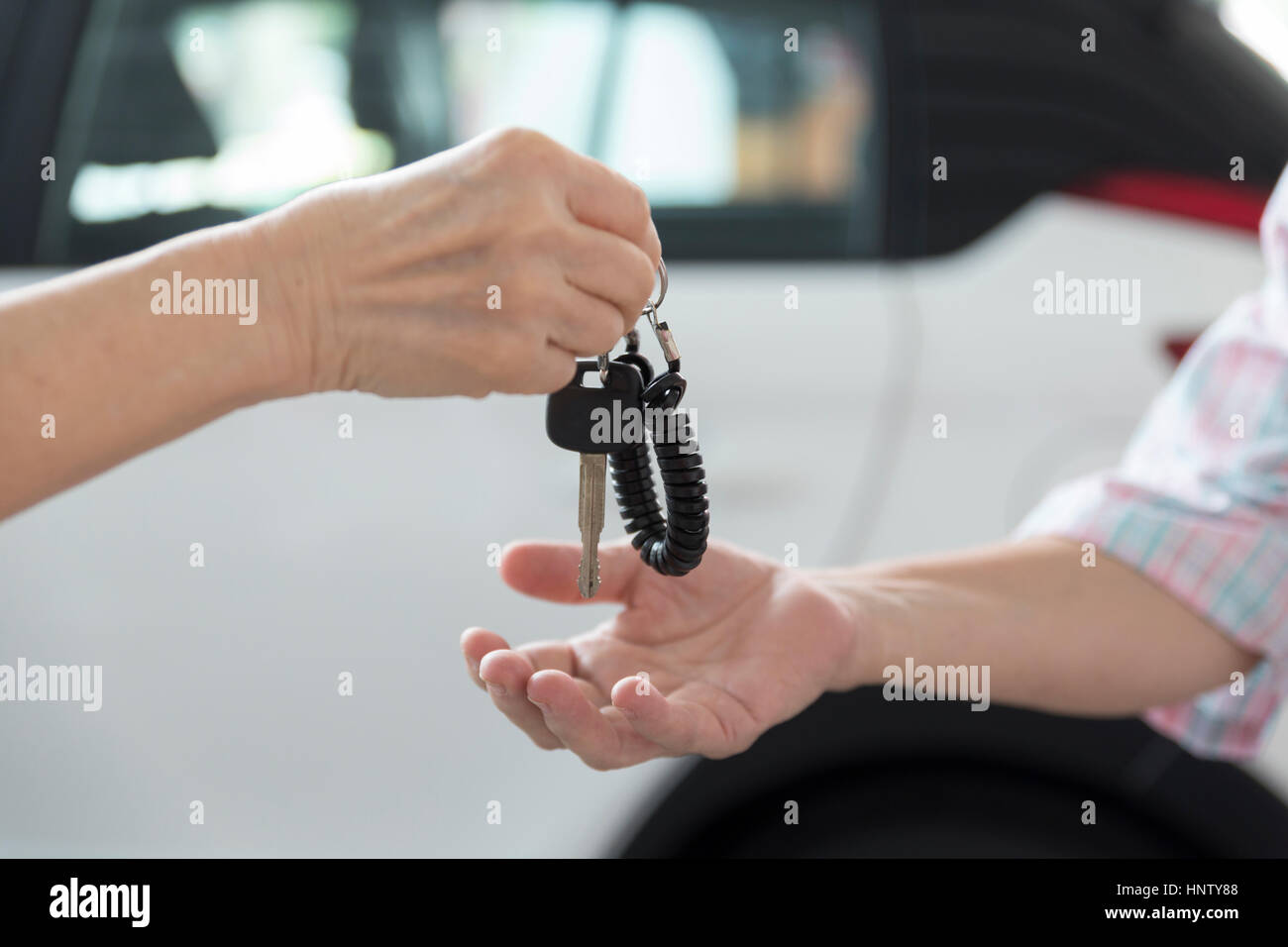 people's hand give and get car key with white car background Stock ...
