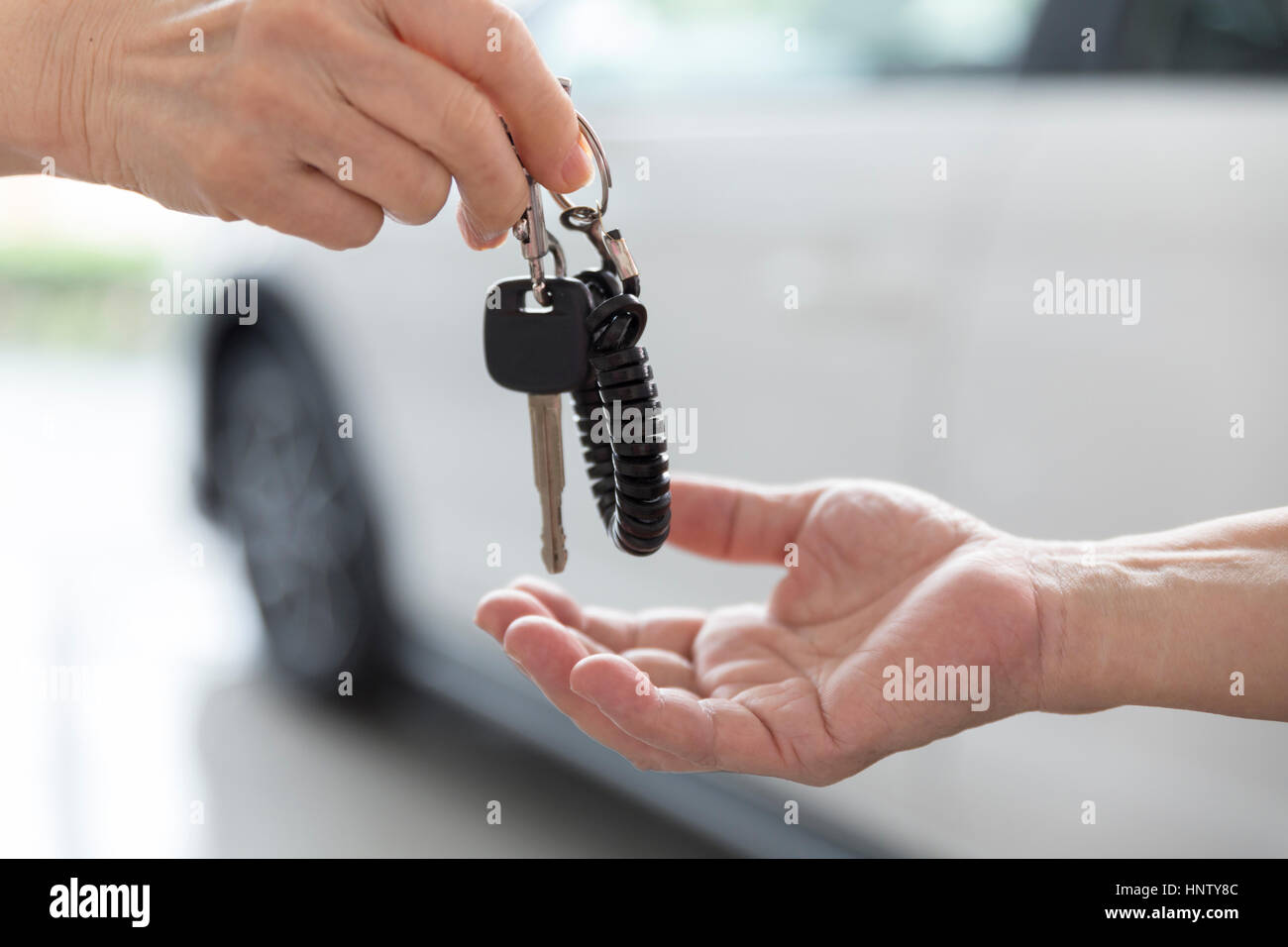 people's hand give and get car key with white car background Stock ...