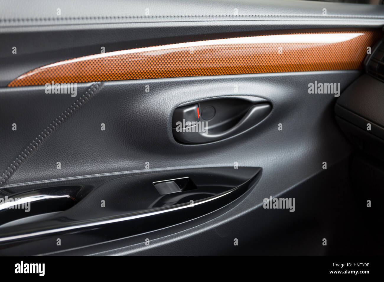chrome door handle inside of new car Stock Photo - Alamy
