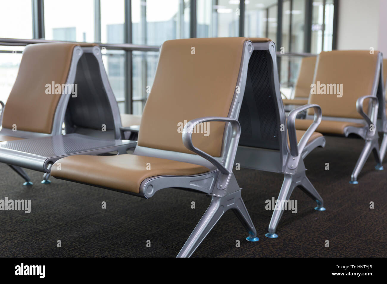 brown leather chair in airport terminal building Stock Photo - Alamy