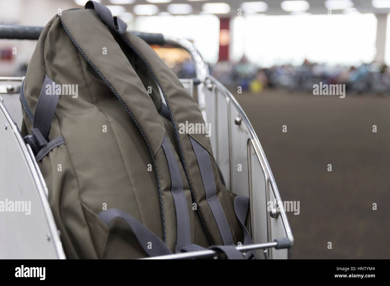 brown rucksack on trolley cart in airport terminal building for travel ...