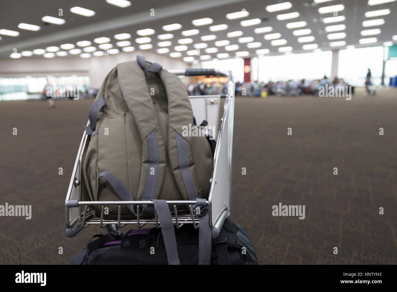 brown rucksack on trolley cart in airport terminal building for travel ...