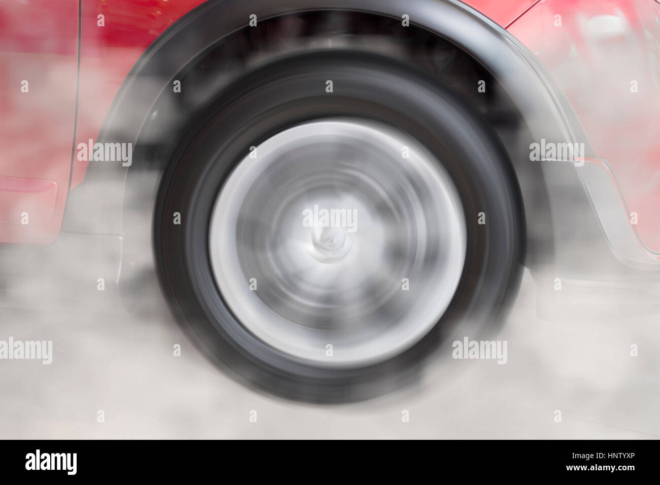 drifting and smoking wheel tire of new red car automobile Stock Photo ...