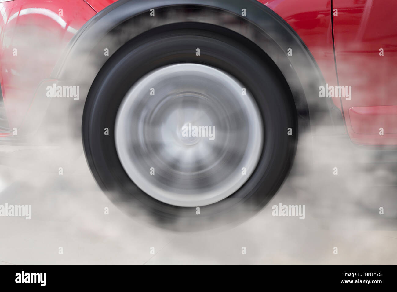 drifting and smoking wheel tire of new red car automobile Stock Photo ...