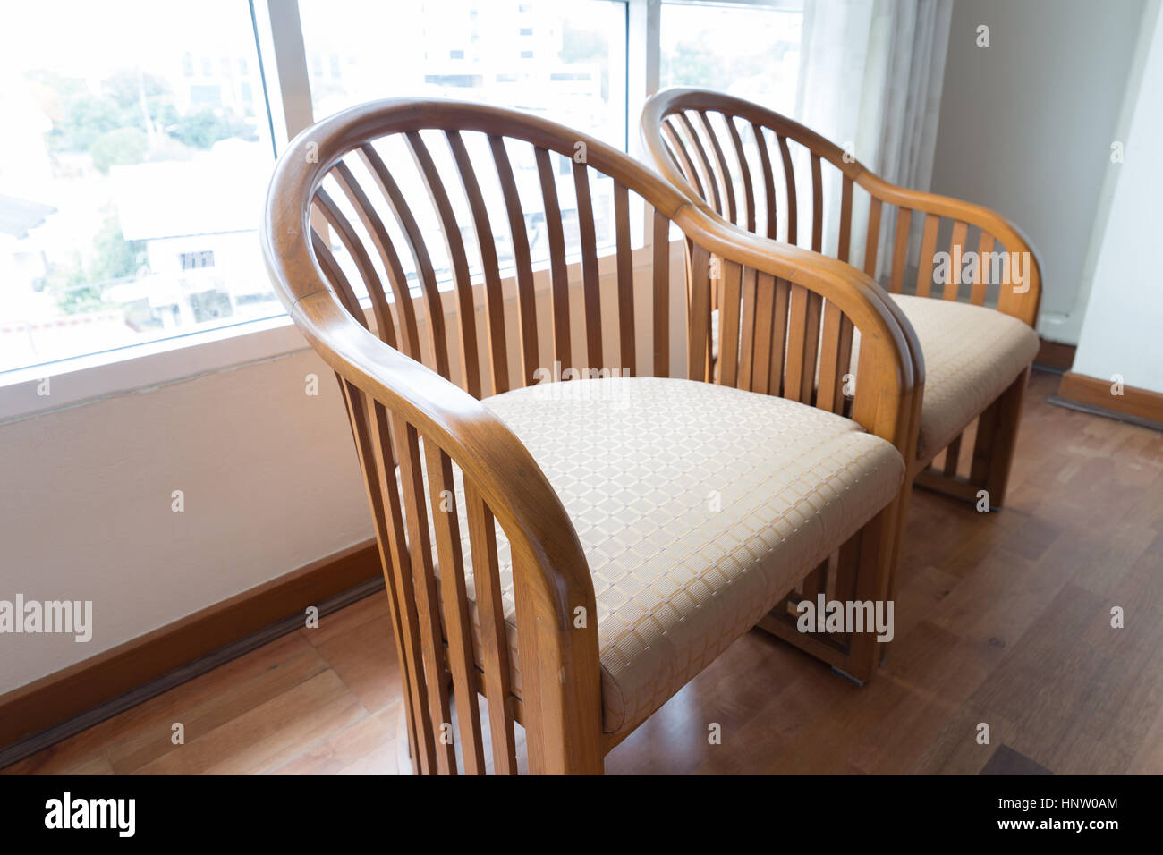 brown wooden chair beside window in apartment room Stock Photo - Alamy
