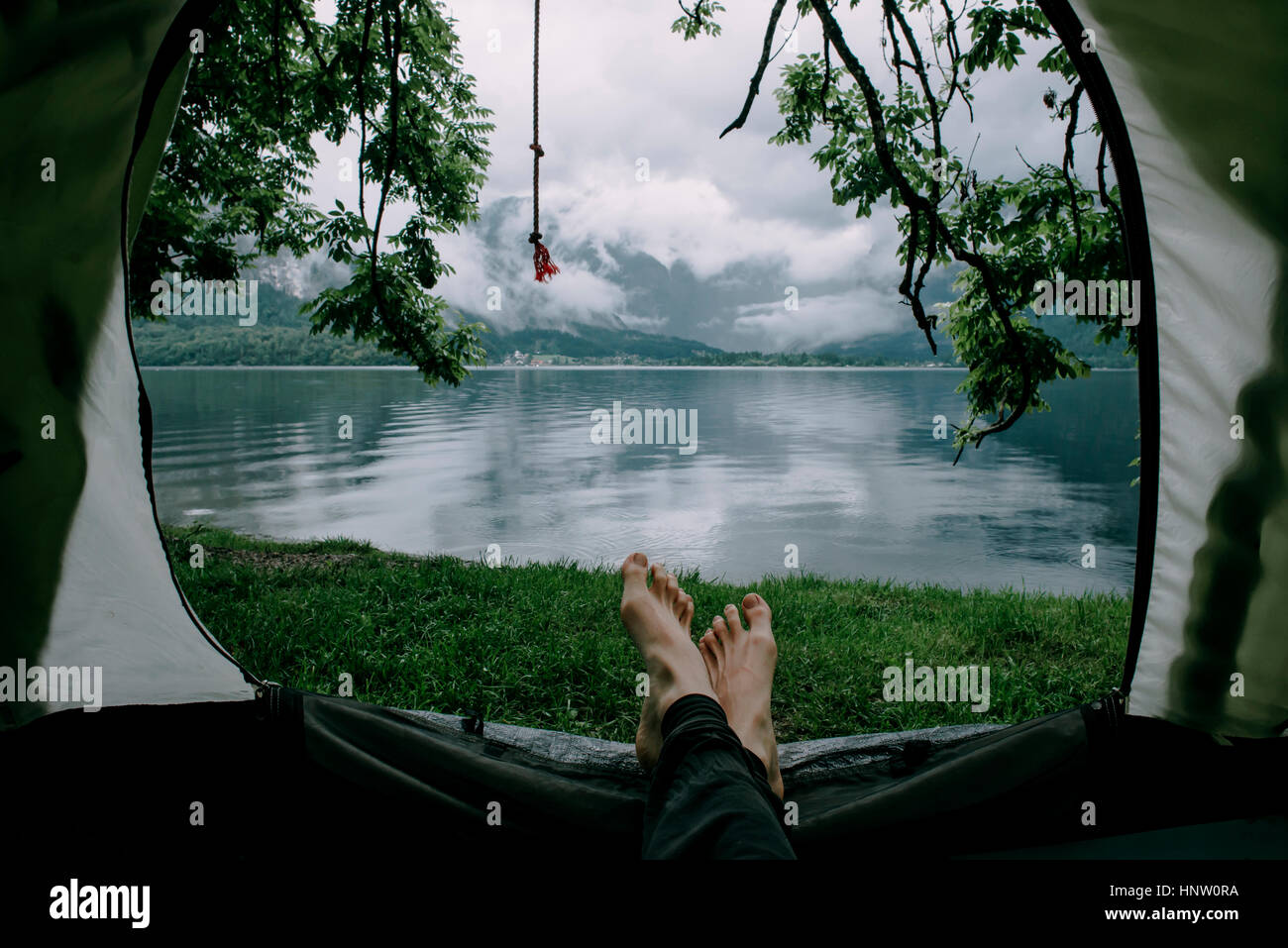 Feet on man laying in camping tent at lake Stock Photo - Alamy