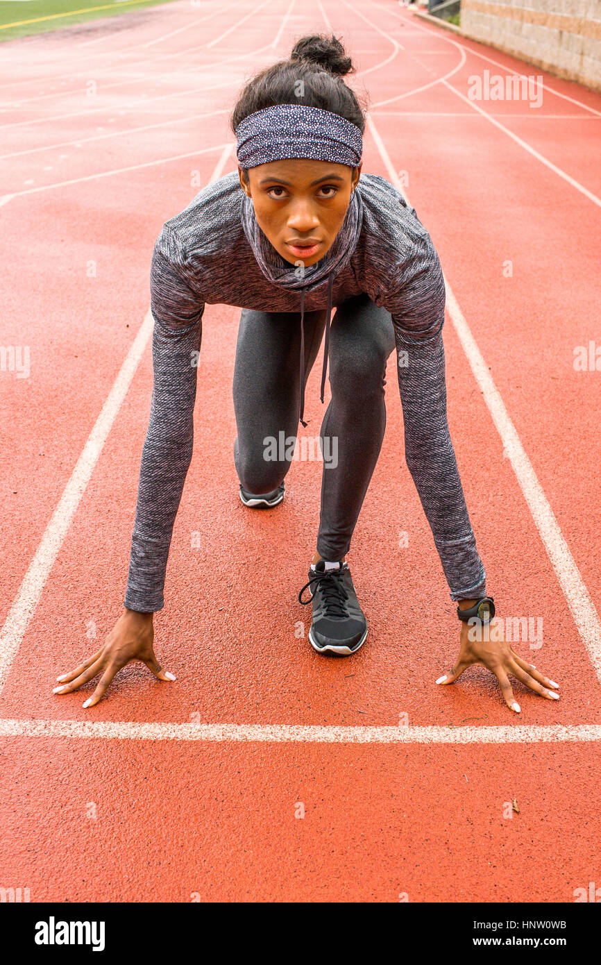 Black woman waiting at starting line on track Stock Photo - Alamy