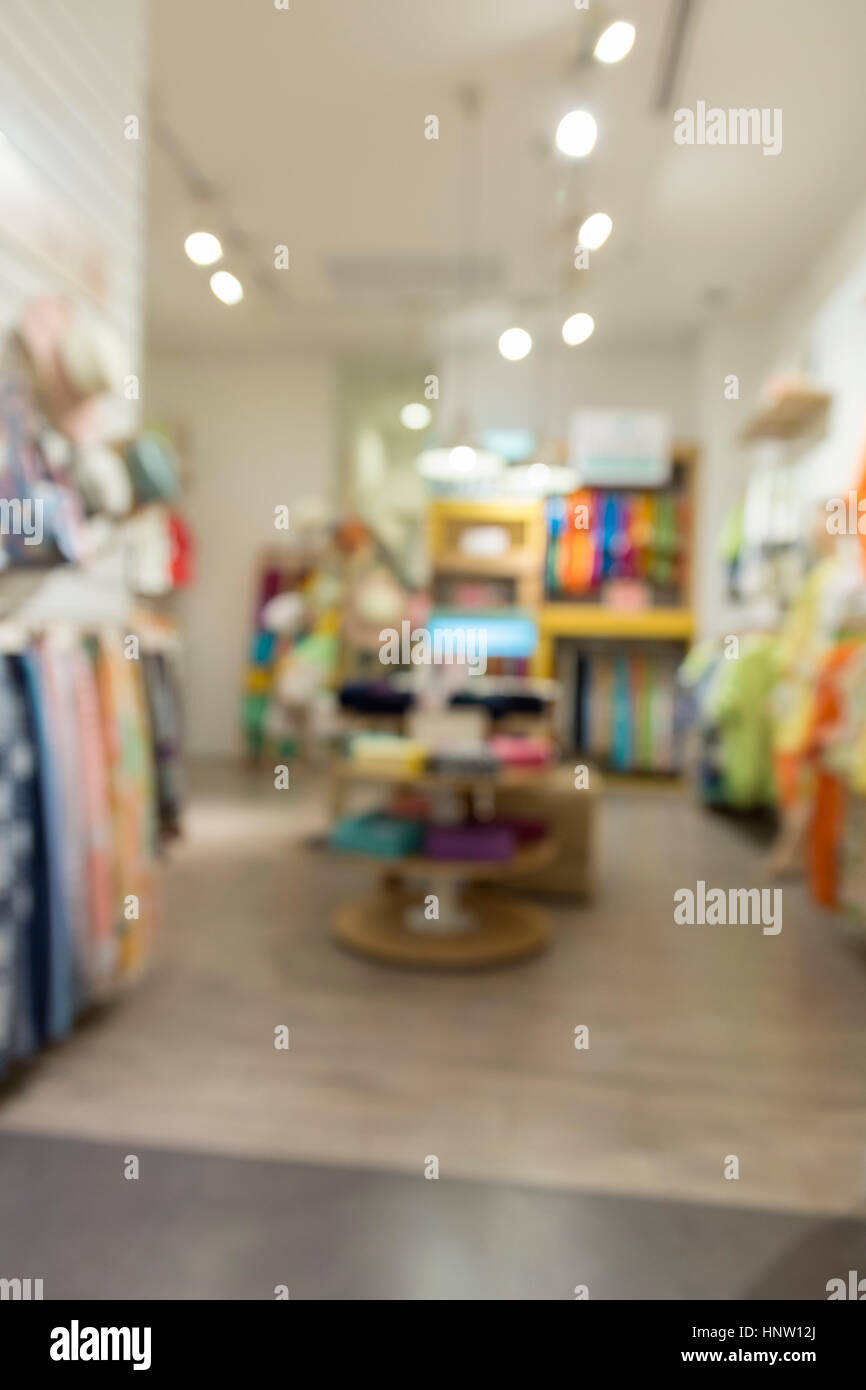 clothing selling in department store for use as shopping concept, blur ...