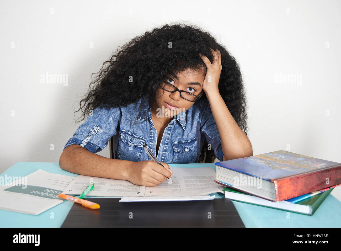 Frustrated Mixed Race teenage girl doing homework Stock Photo - Alamy