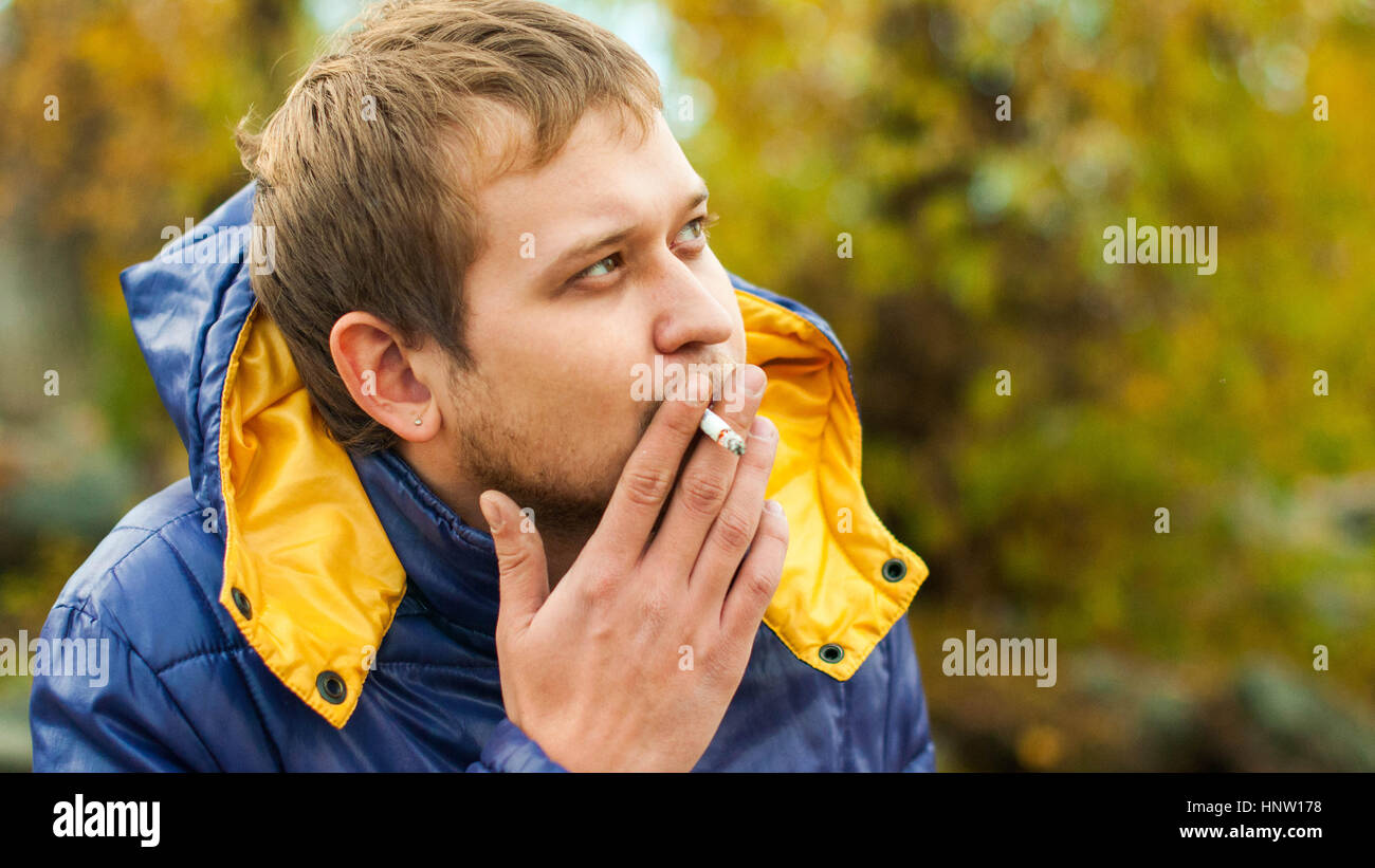 Man smoking cigarette in the forest hi-res stock photography and images ...