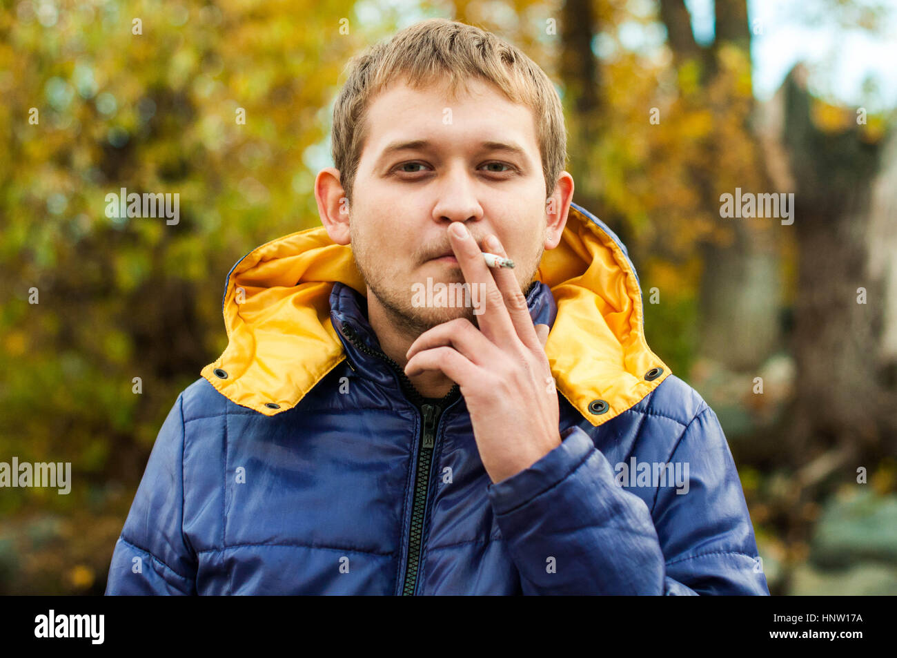 Guy smoking cigarette in forest hi-res stock photography and images - Alamy