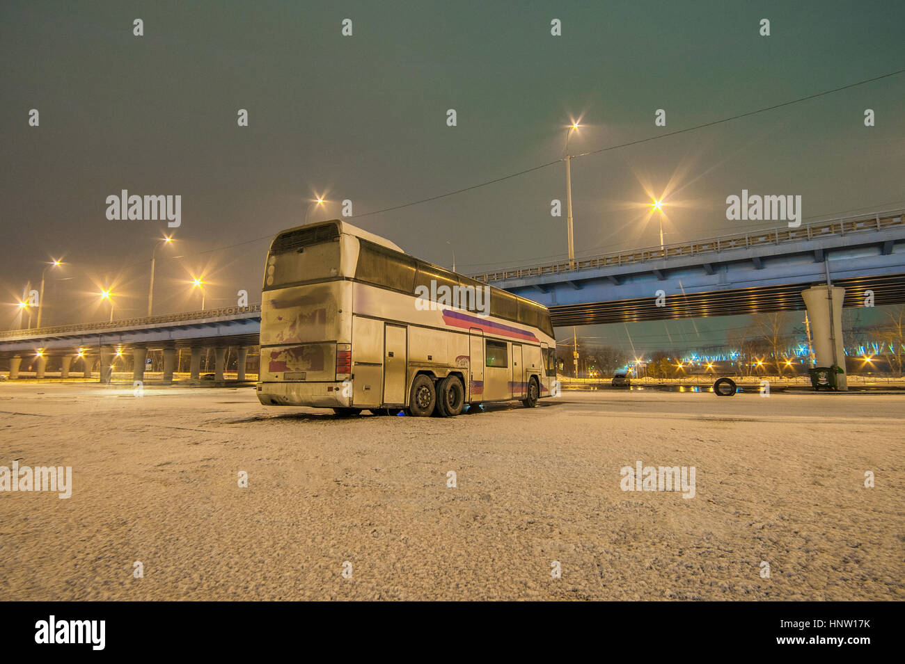 intercity bus stands in a snowy winter city park at night Stock Photo ...