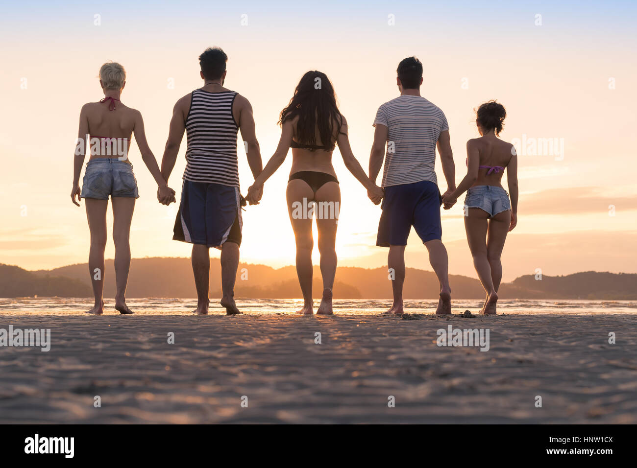 Young People Group On Beach At Sunset Summer Vacation, Friends Holding ...