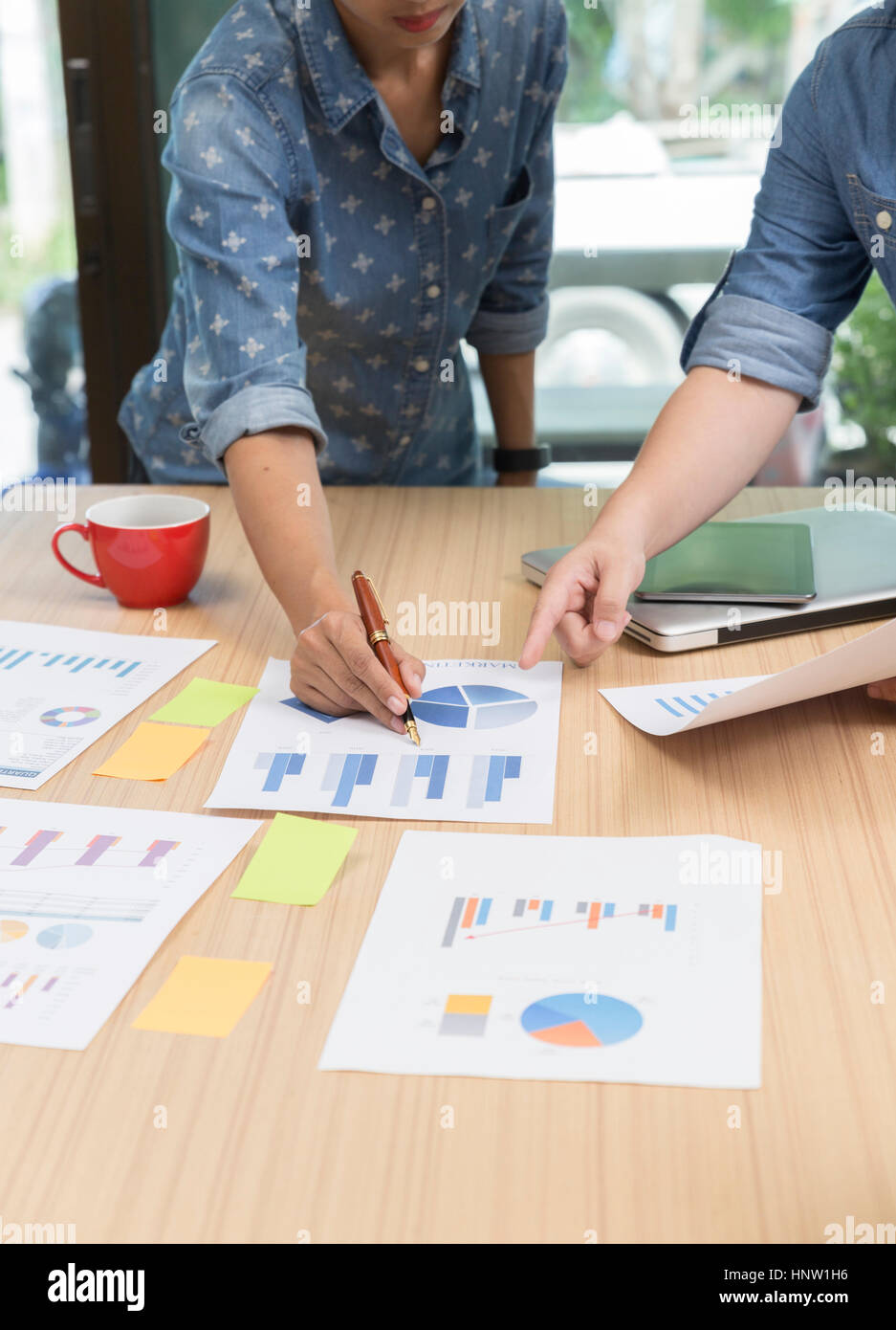 people with laptop computer, document, pen, digital tablet and coffee cup for use as working ...