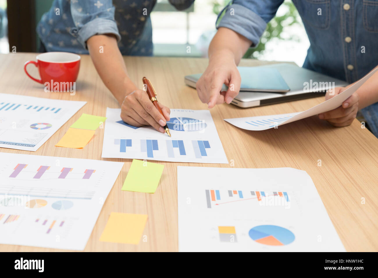 people with laptop computer, document, pen, digital tablet and coffee cup for use as working ...
