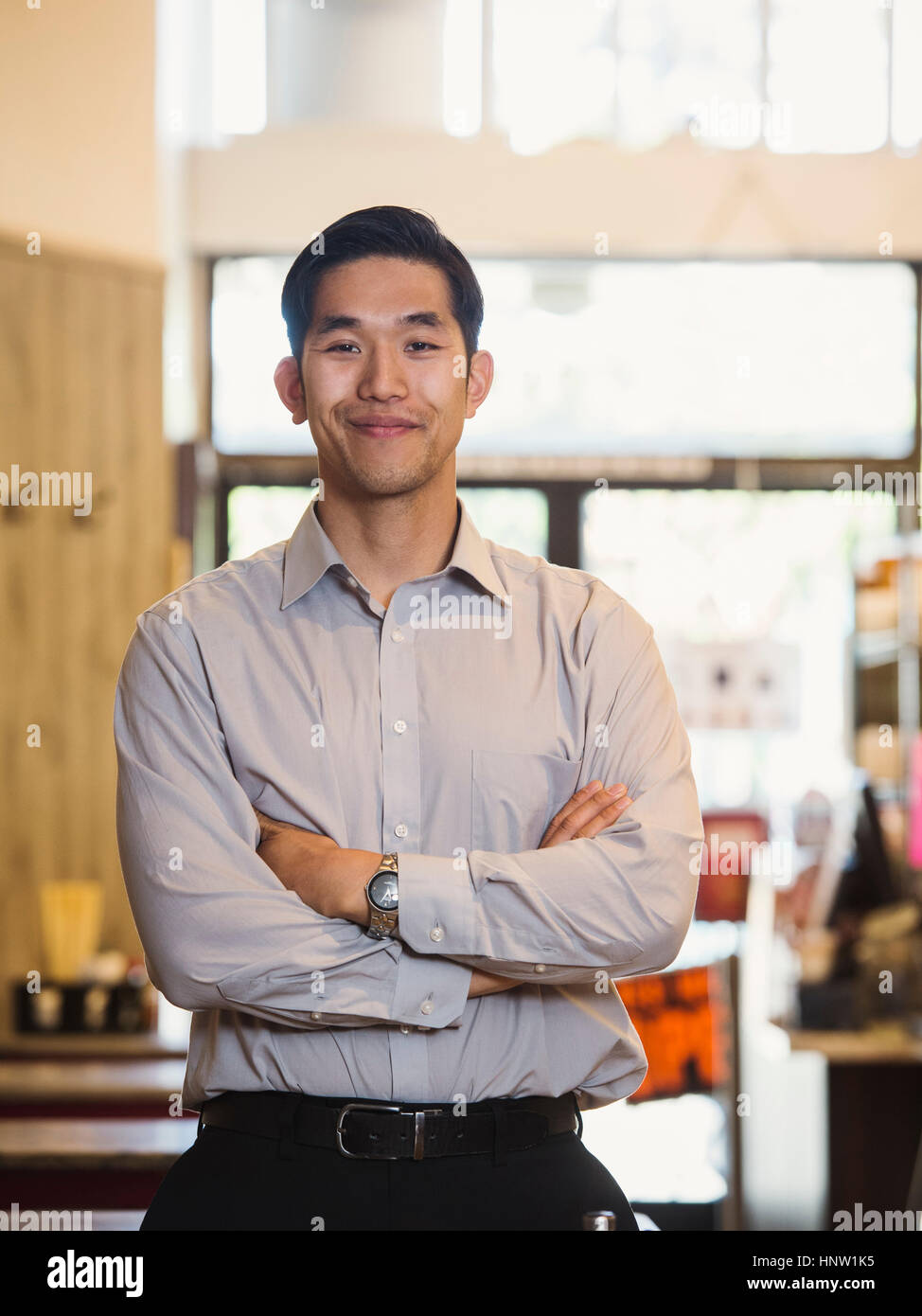 Smiling Chinese man posing in restaurant Stock Photo - Alamy
