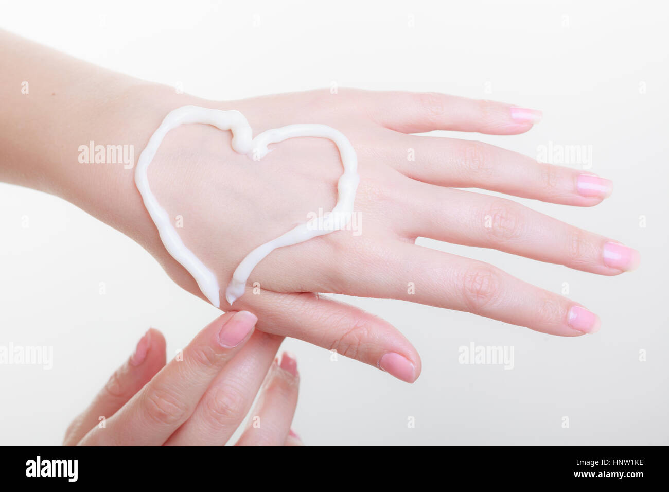 Beauty, cosmetics, concept. Cream on woman hand, heart shape. Studio ...
