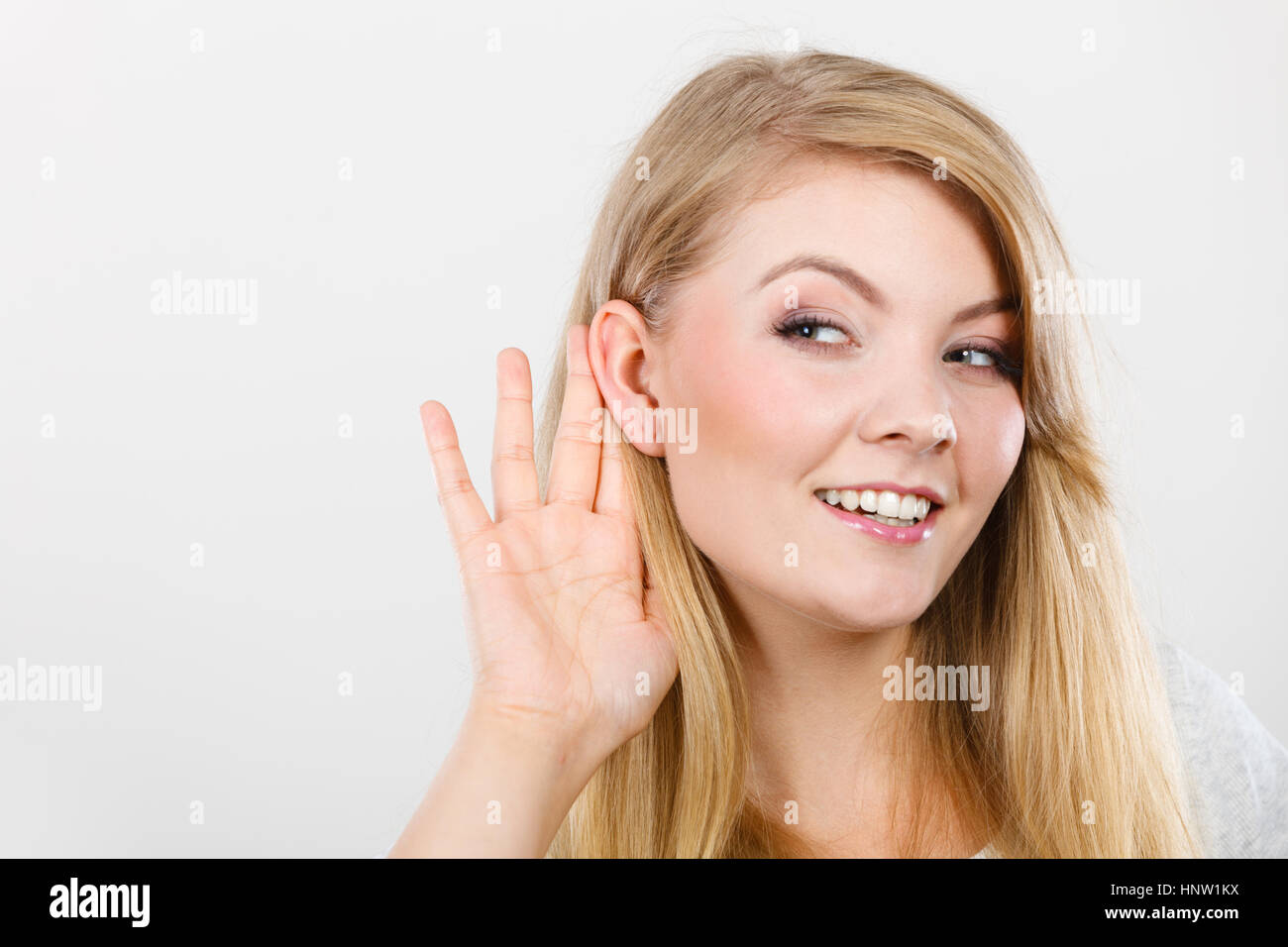 Cupped hand to ear hi-res stock photography and images - Alamy