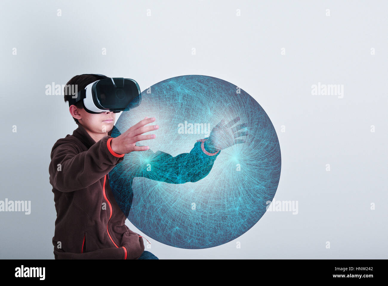 Mixed Race boy wearing VR goggles holding sphere Stock Photo - Alamy