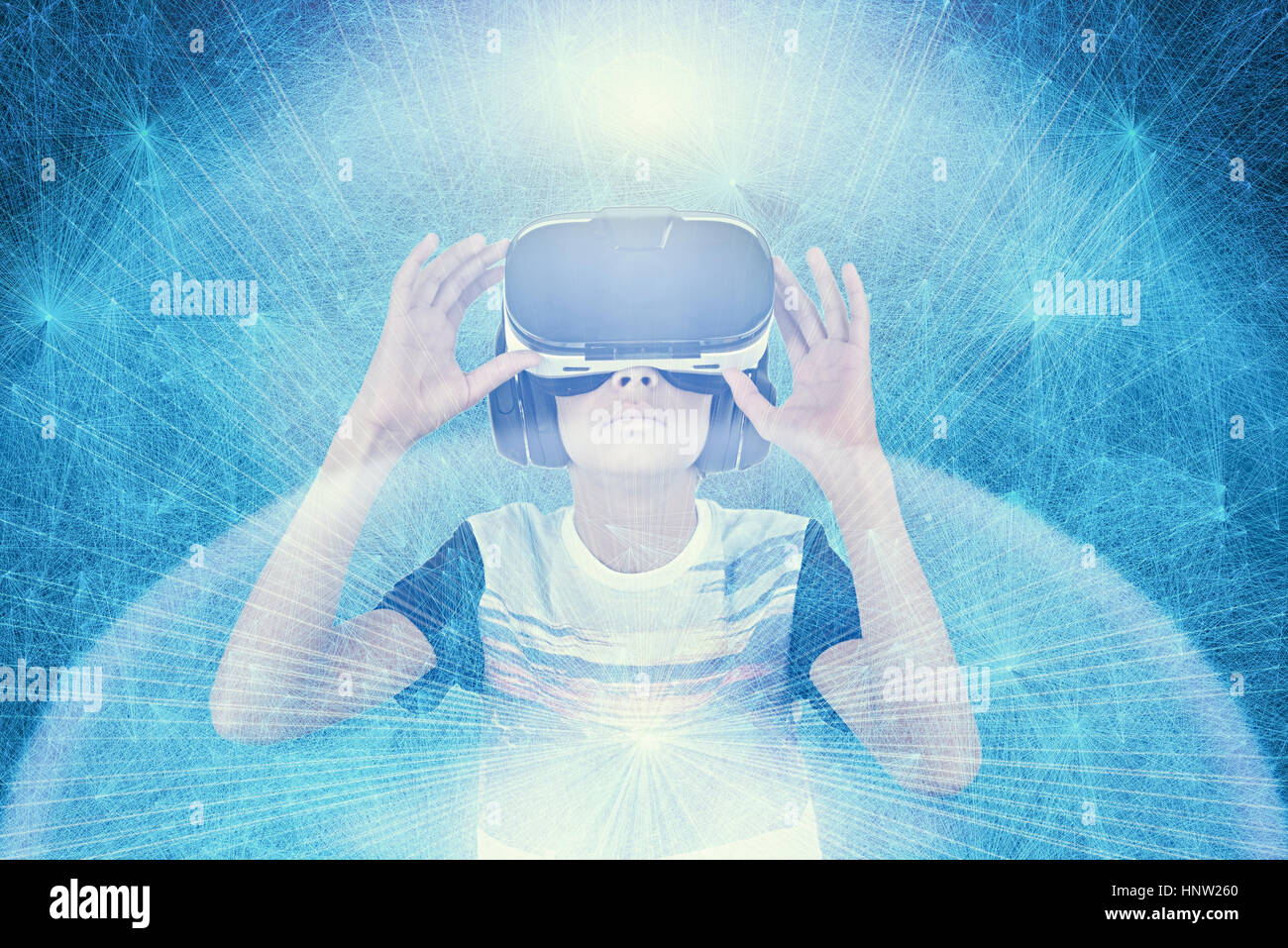 Mixed Race boy wearing VR goggles in cyberspace Stock Photo - Alamy
