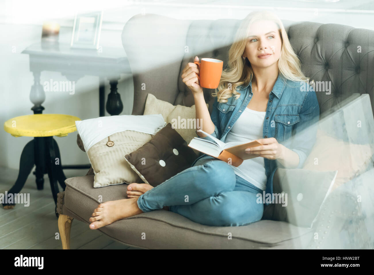 Pretty woman reading book at home Stock Photo - Alamy