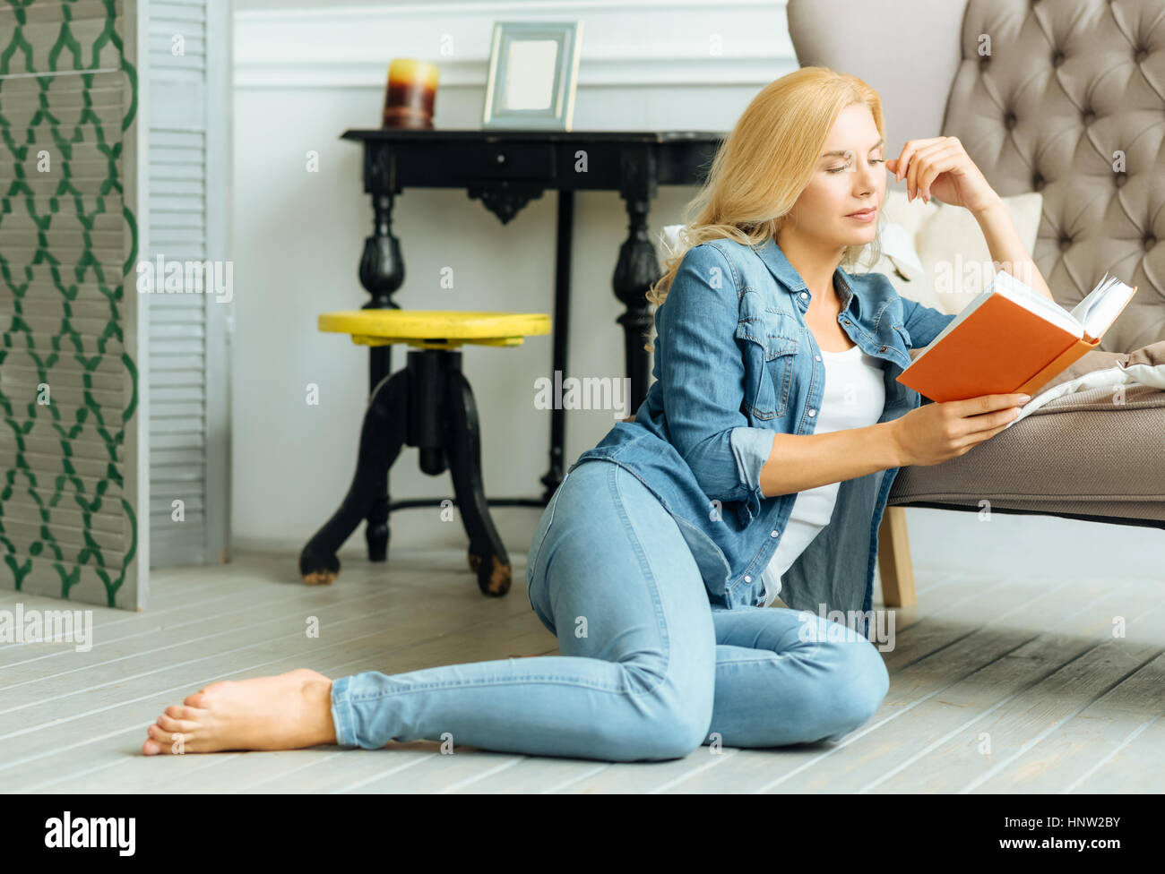 Beautiful woman reading book at home Stock Photo - Alamy