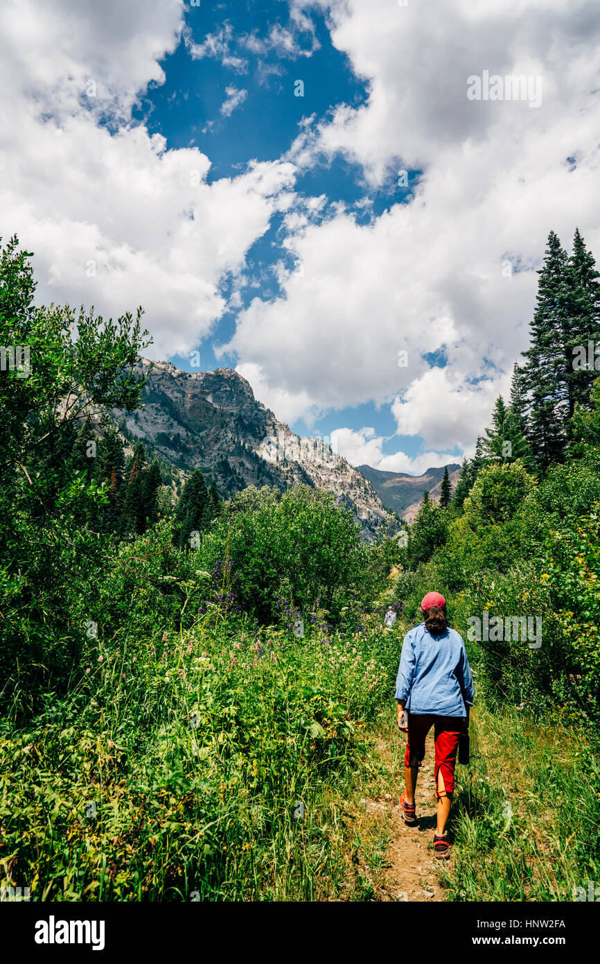 Caucasian woman hiking on path in mountains Stock Photo - Alamy