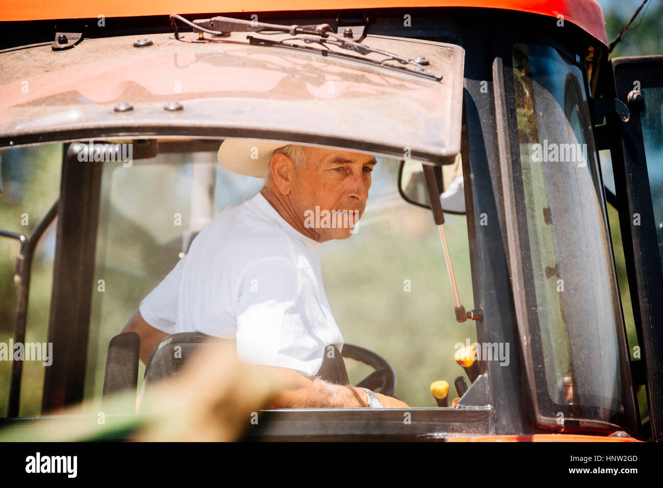 Caucasian farmer driving tractor Stock Photo - Alamy