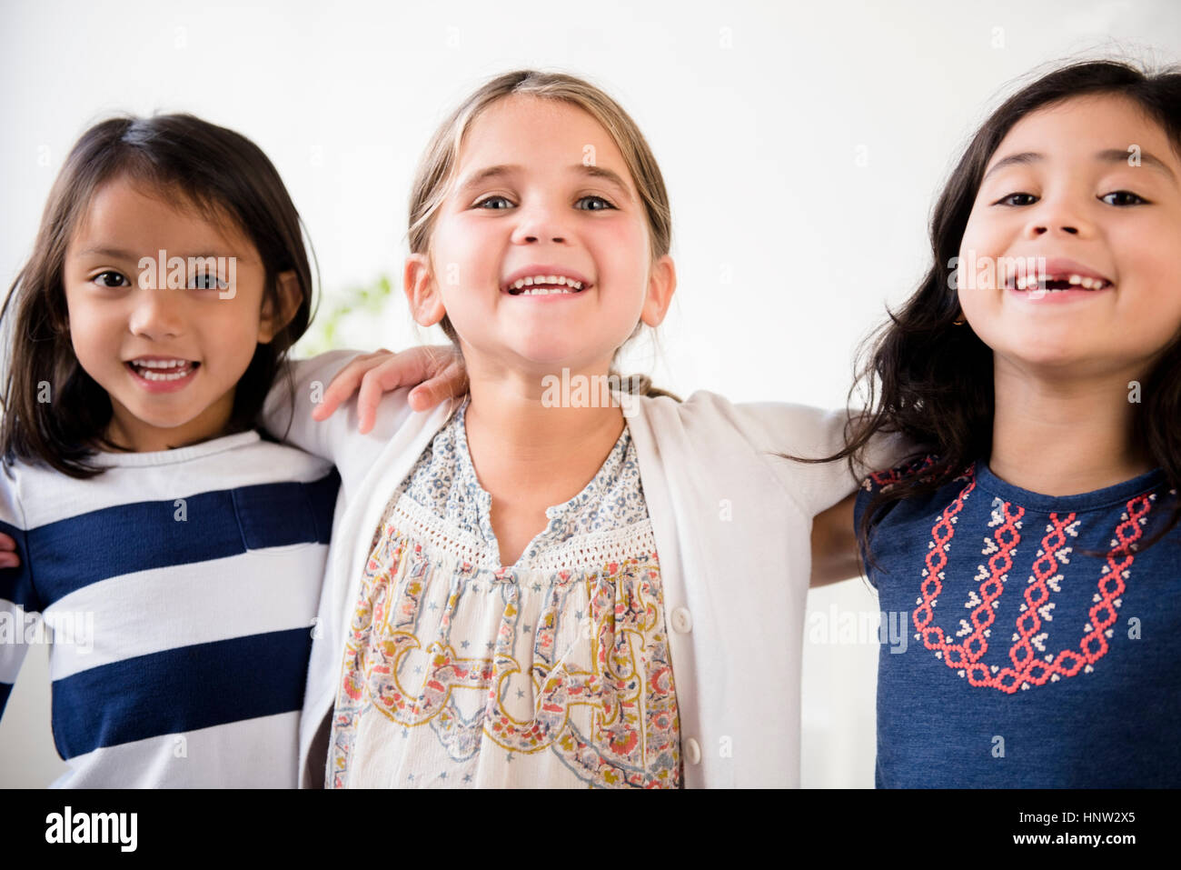 Portrait of smiling girls hugging Stock Photo - Alamy