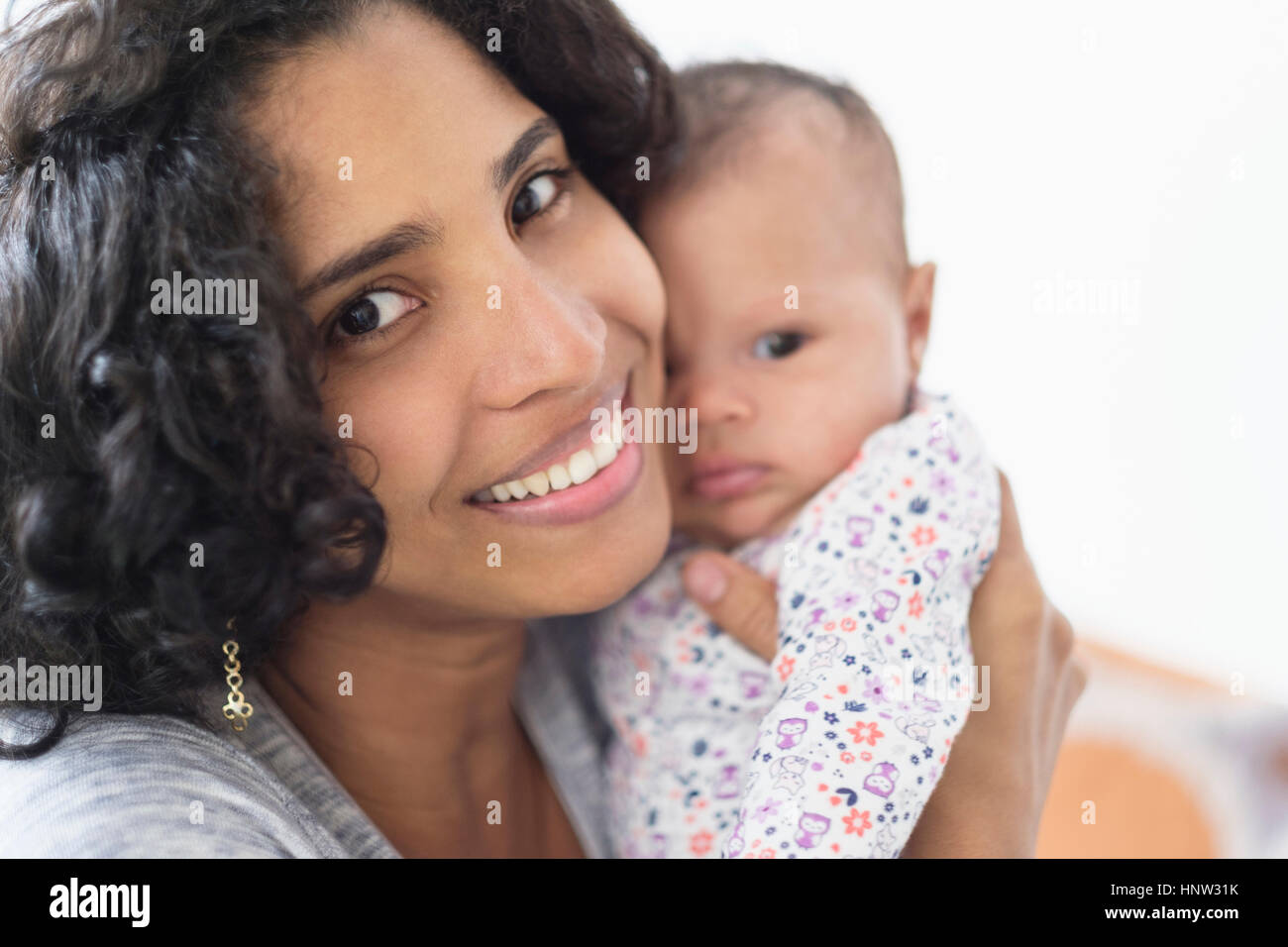 Hispanic mother posing with baby daughter Stock Photo - Alamy