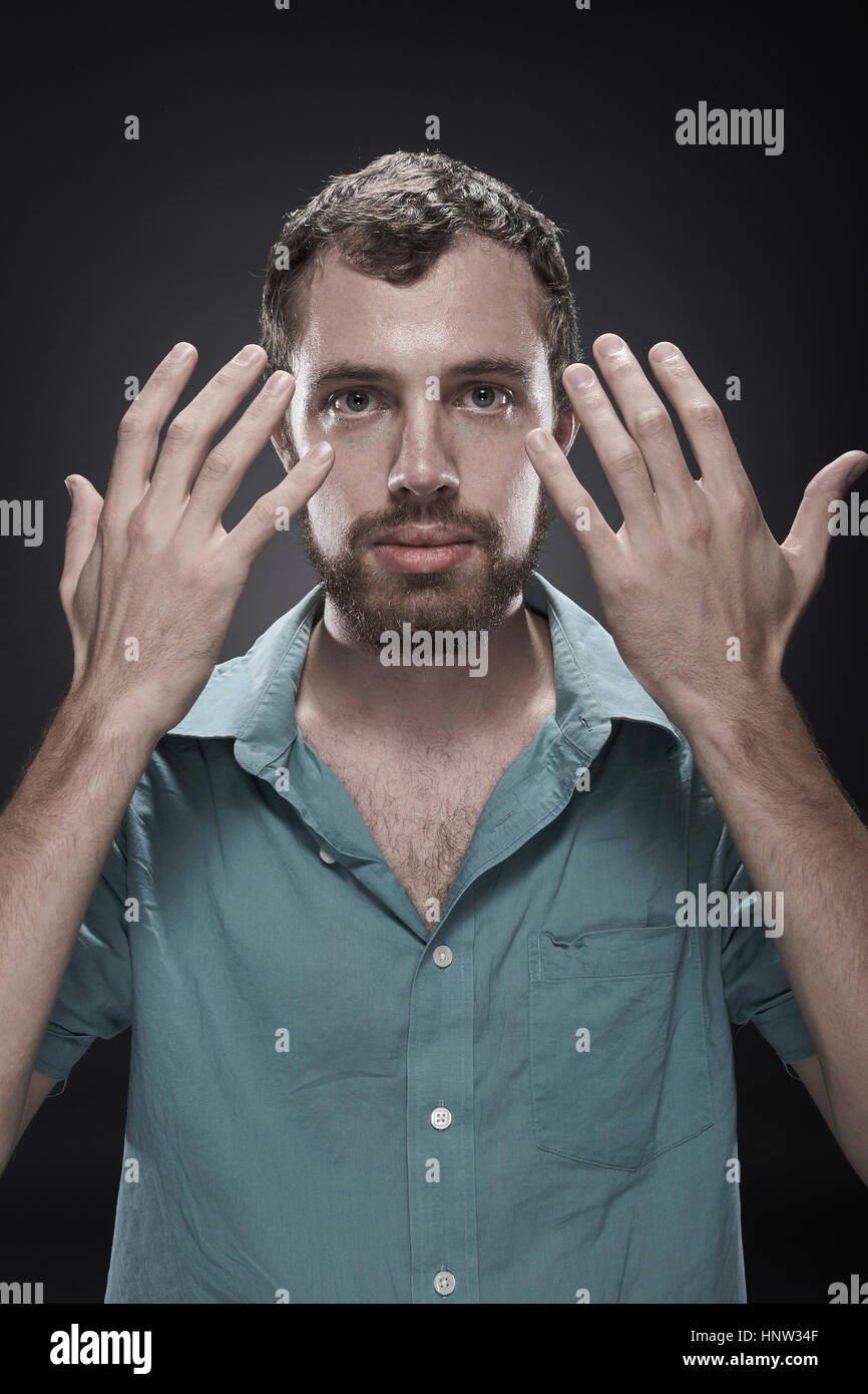 Serious man showing hands Stock Photo - Alamy